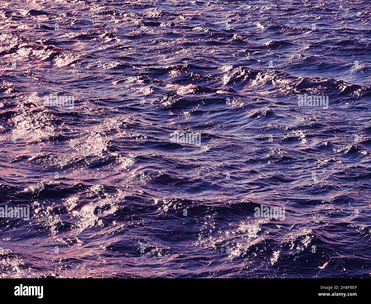 Sea, texture and coastal nature concept. Ocean water at sunset as ...