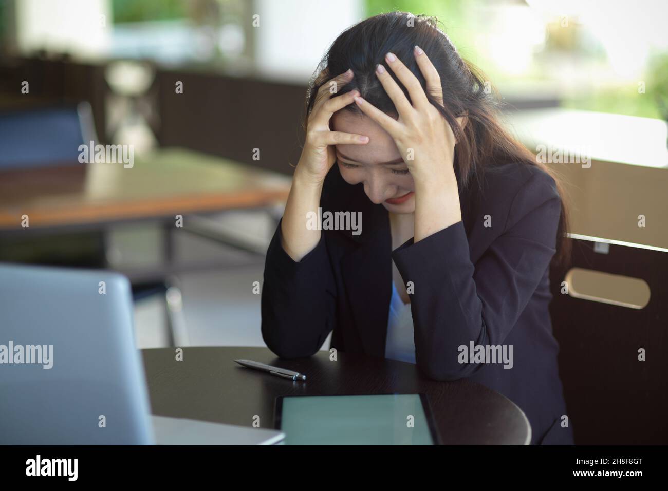 A thoughtful stressed female worker upset with her work result ...