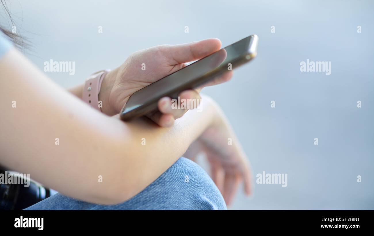 Close-up image of a female using modern smart mobile phone. internet ...