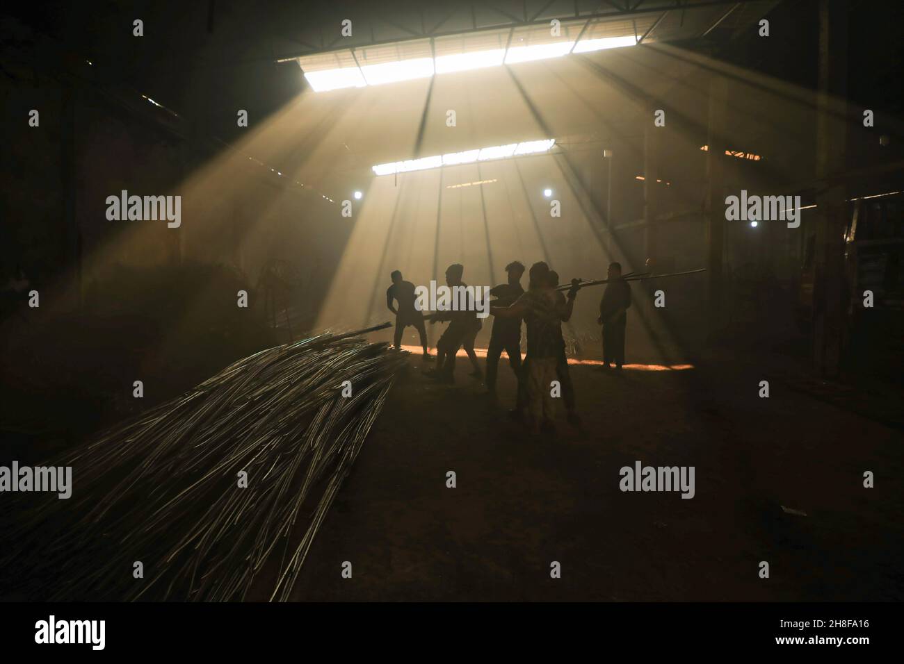 Dhaka, Bangladesh. 29th Nov, 2021. Silhouettes of men working inside a ...
