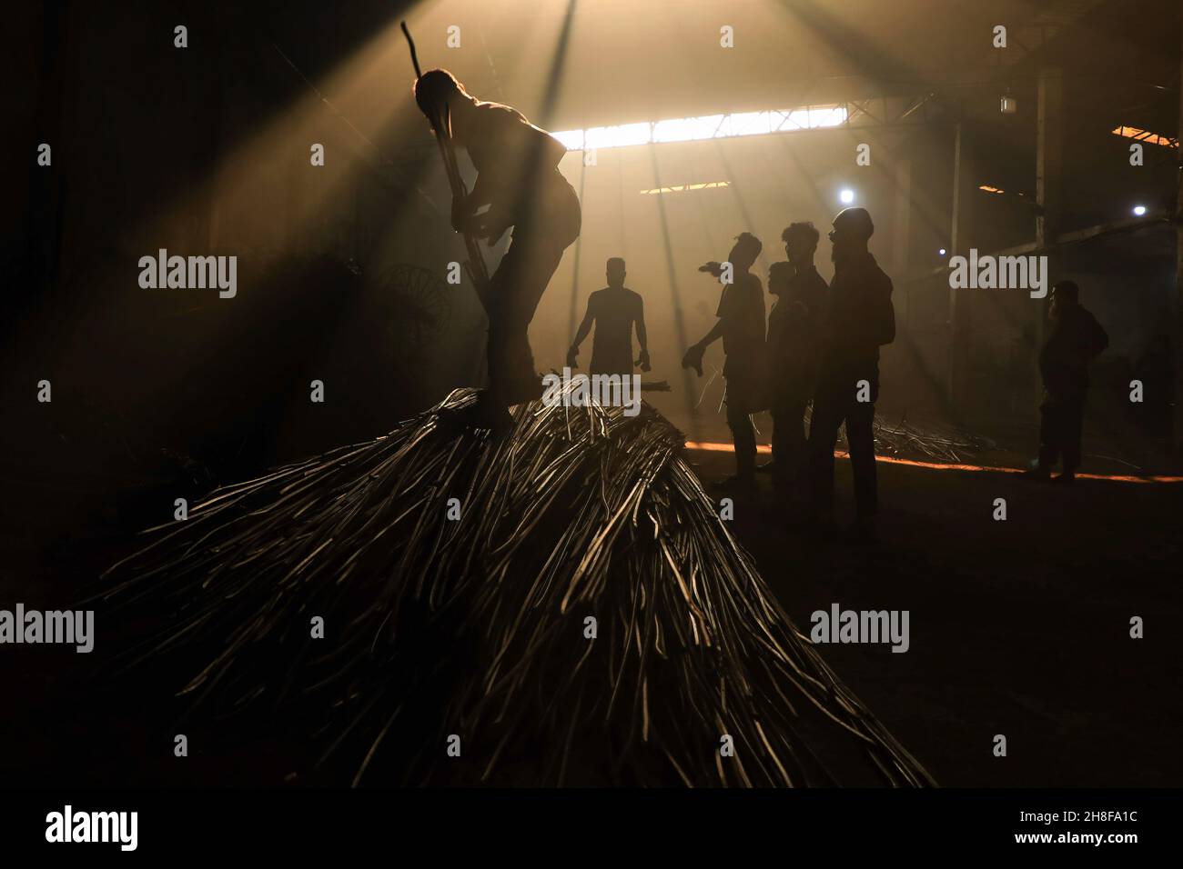 Dhaka, Bangladesh. 29th Nov, 2021. Silhouettes of men working inside a ...