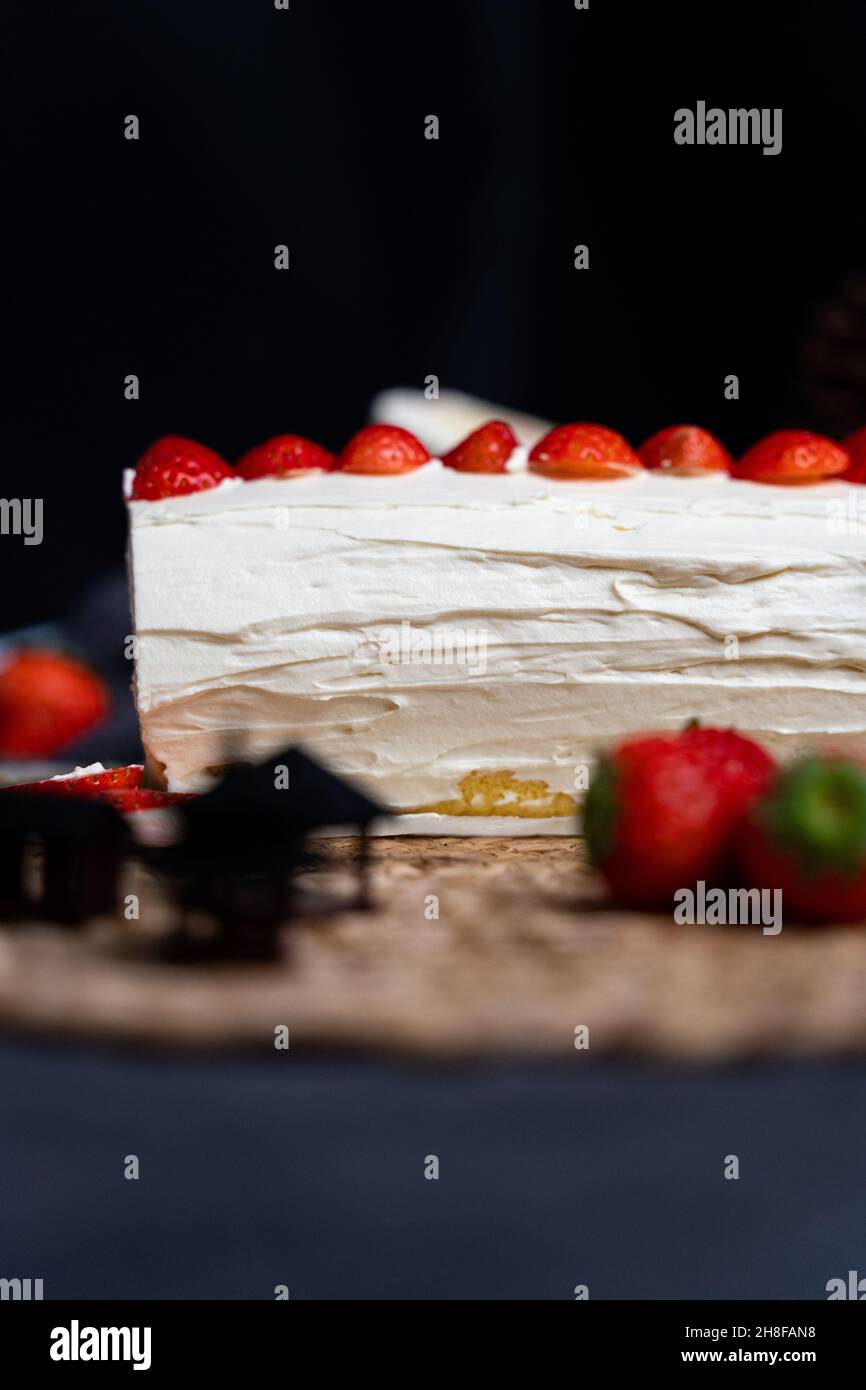 Strawberry log cream cake with black background Stock Photo - Alamy