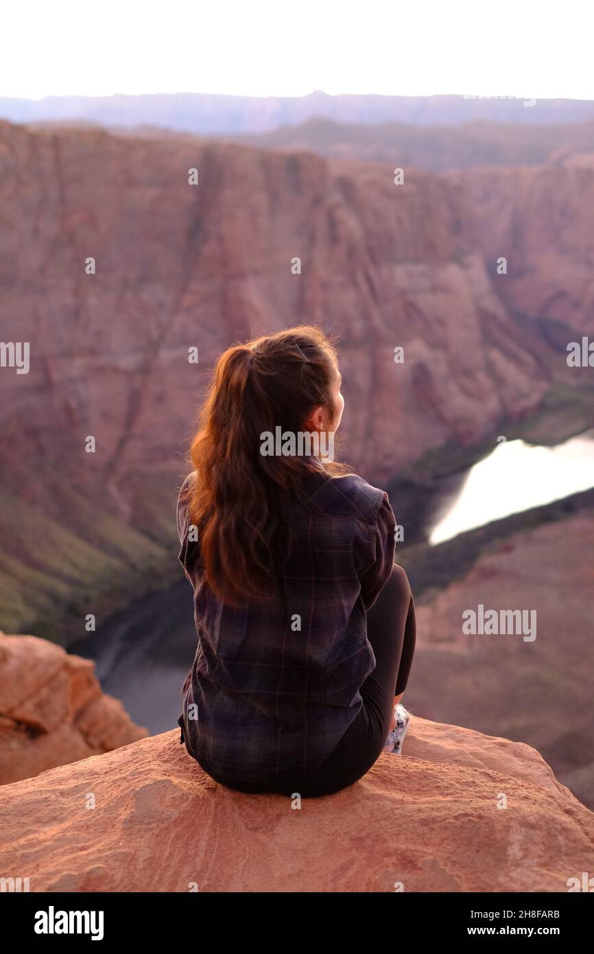 Woman sitting on edge cliff hi-res stock photography and images - Alamy