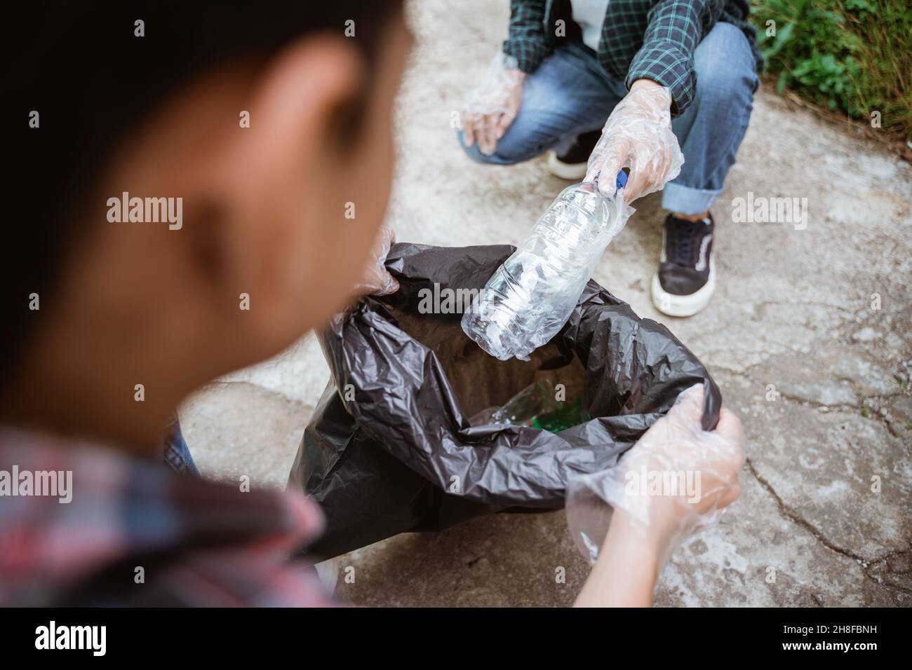 young volunteers keep the environment clean by picking up trash Stock ...