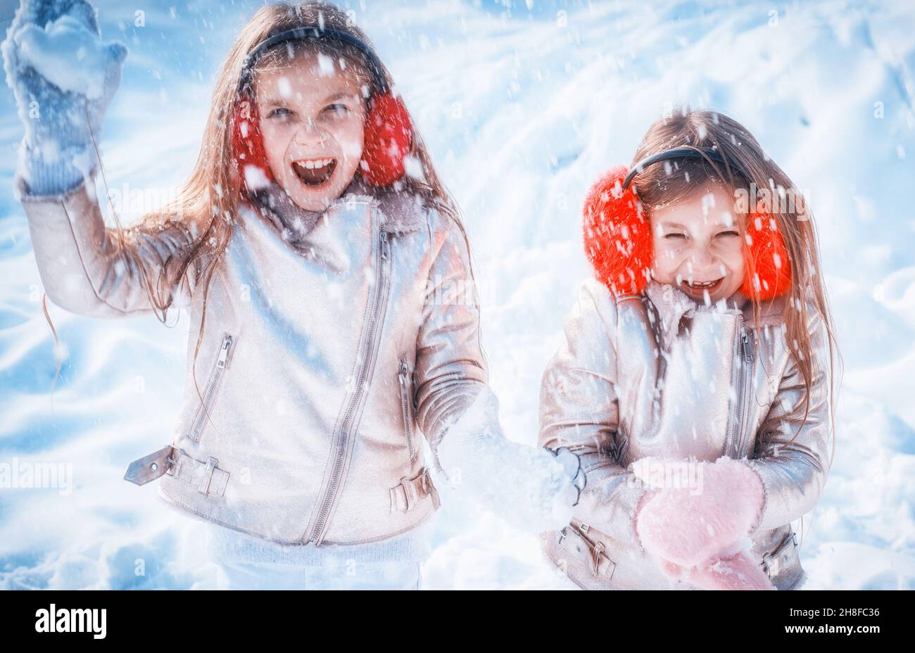 Portrait of sisters having fun in snow hi-res stock photography and ...