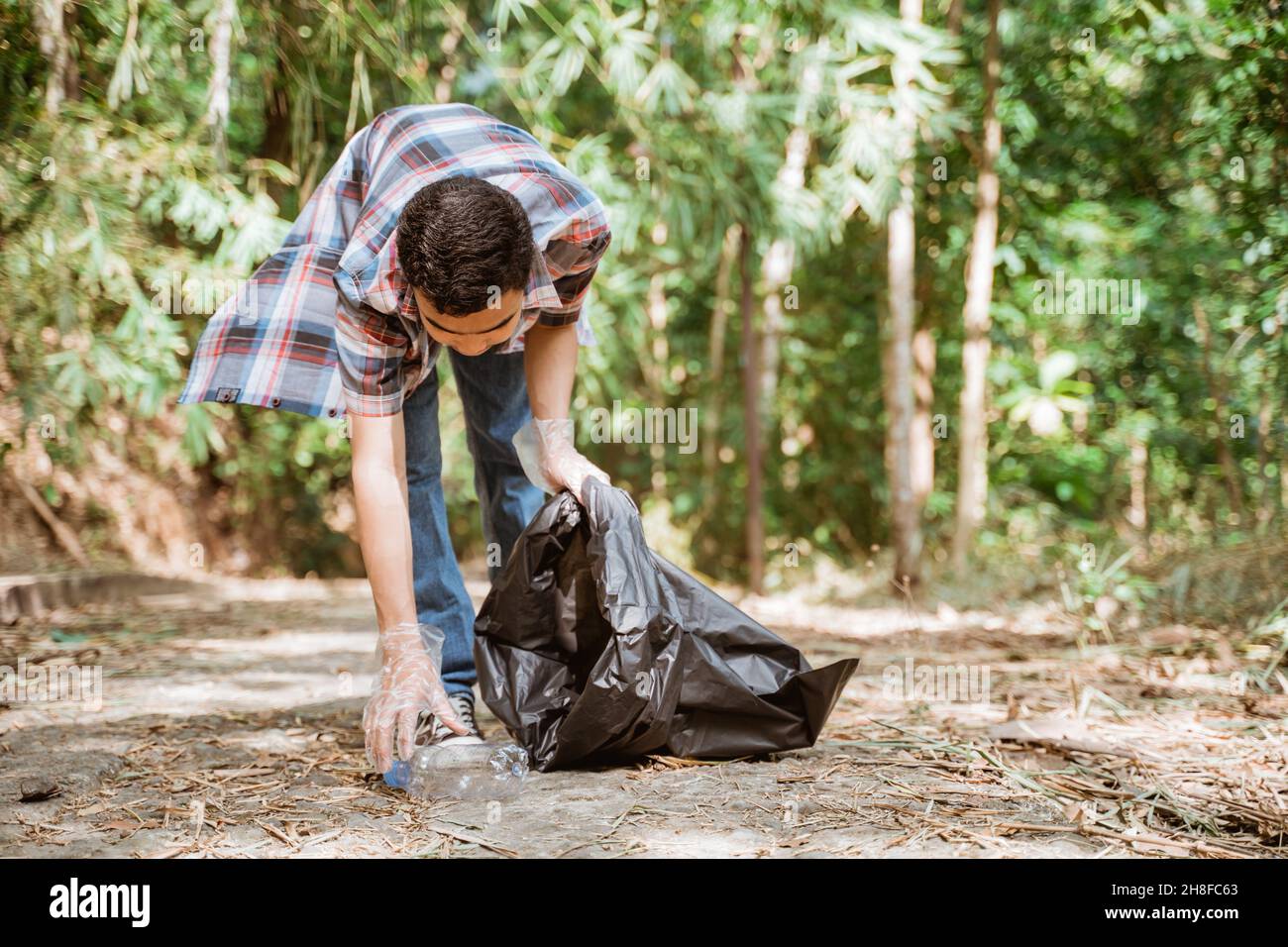 young volunteers keep the environment clean by picking up trash Stock ...