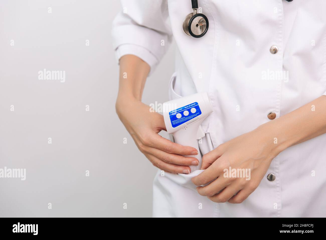 Temperature measurement gun in doctor hands. Close-up shot of doctor ...