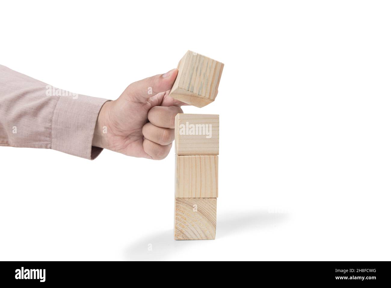 Hand put the stack of wooden block toy isolated over white background ...