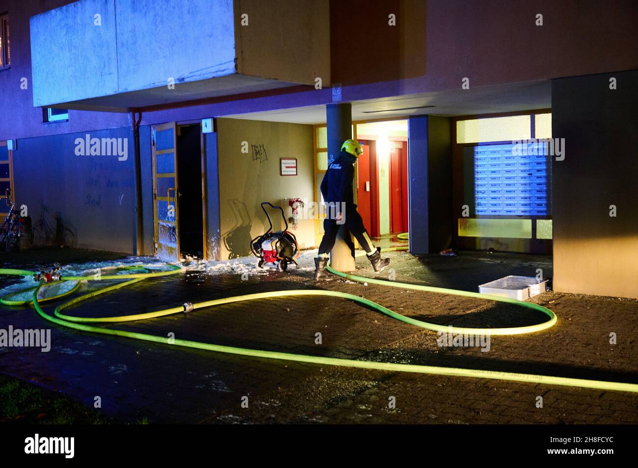 Berlin, Germany. 30th Nov, 2021. A firefighter goes into a basement of ...