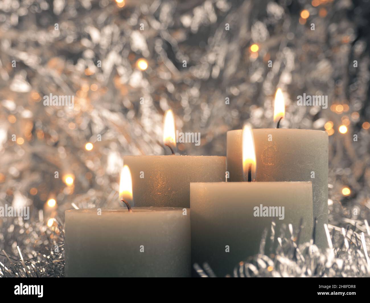 Fourth Advent candle burns, silver background with text free space ...
