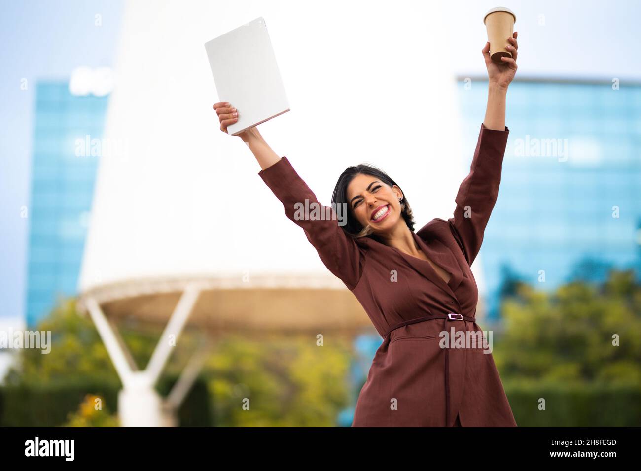 Cheerful and smiling successful business woman celebrating Stock Photo ...