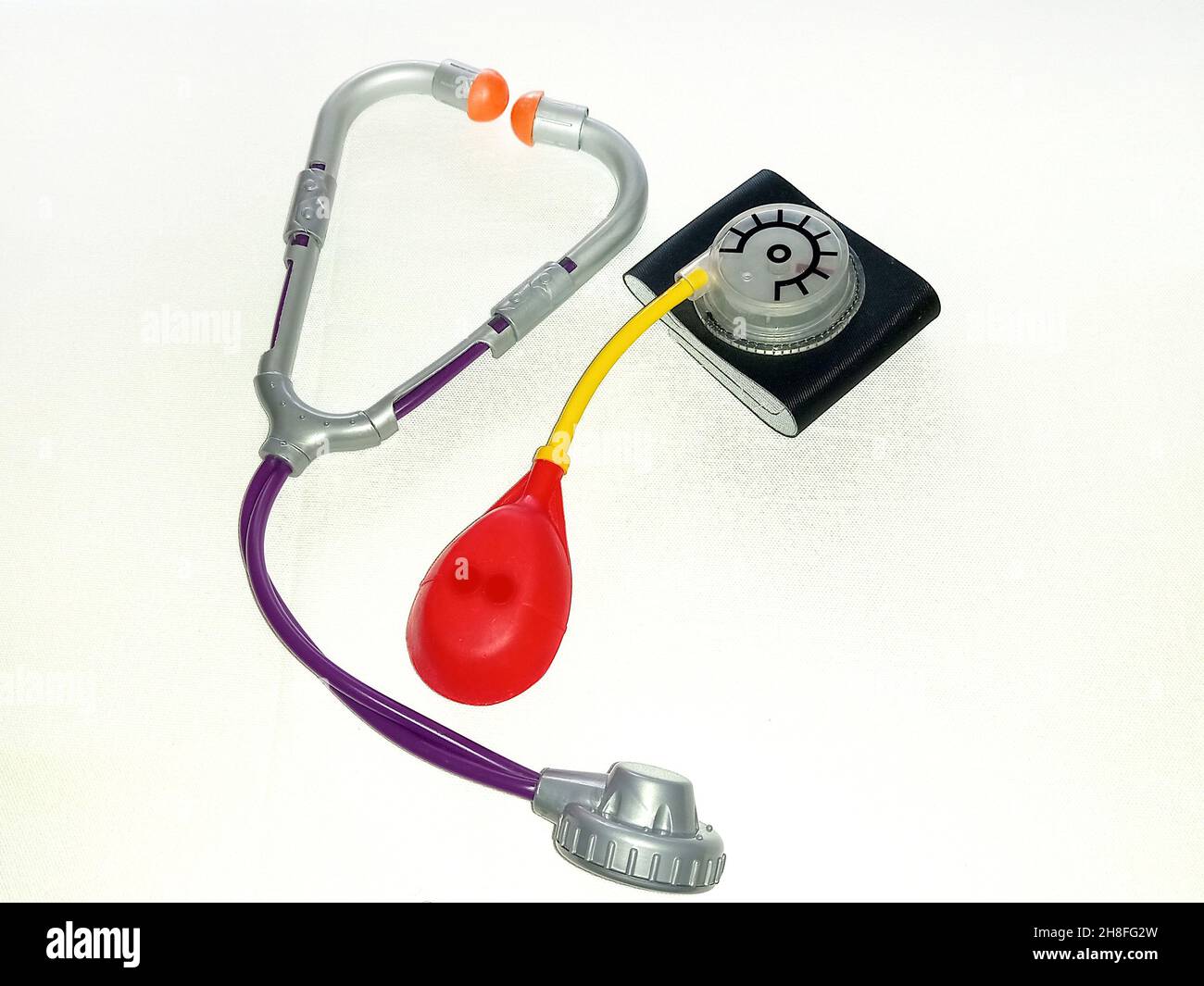 blood pressure meter and phonendoscope toy on white blanket funny for ...