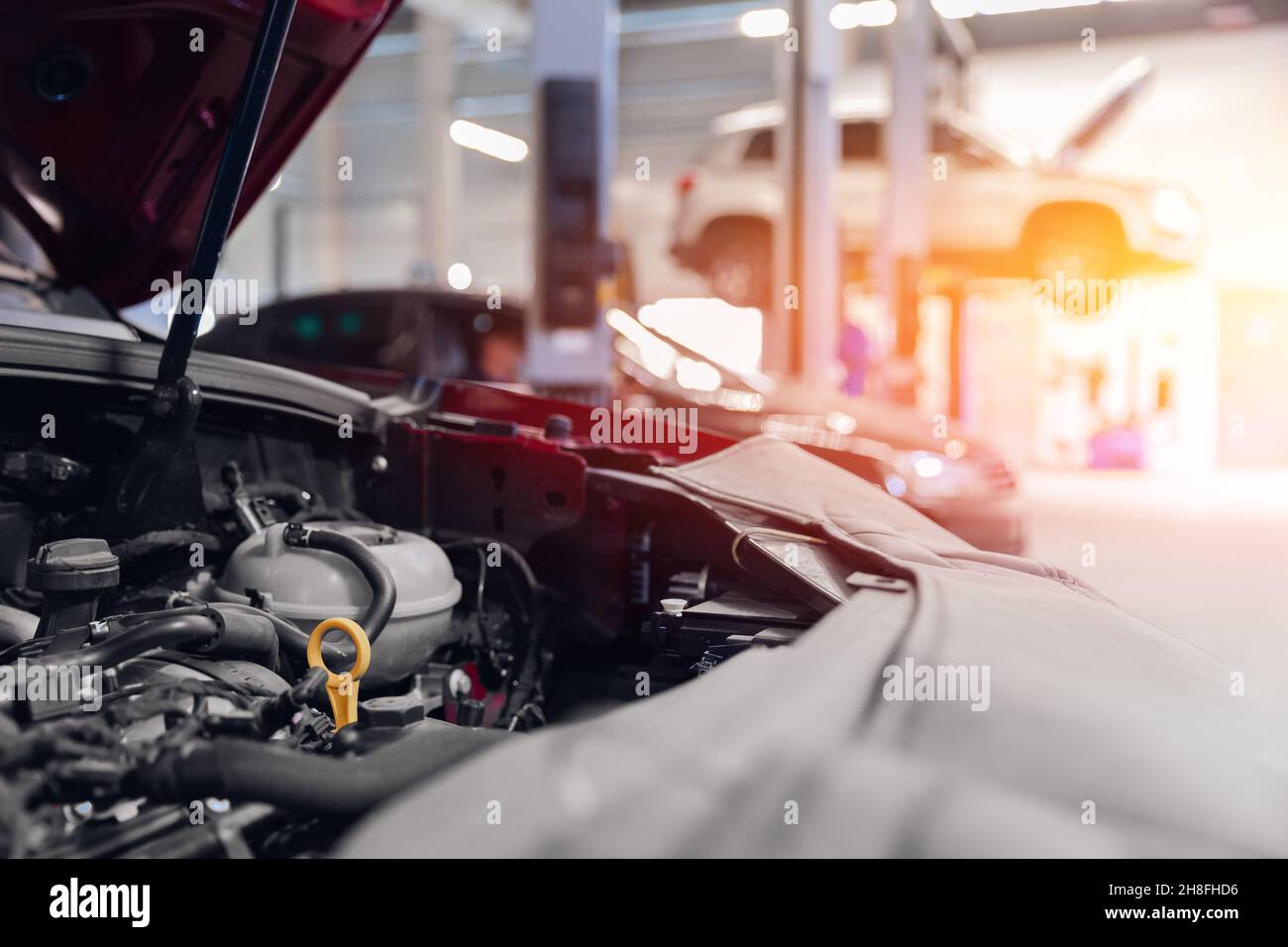 Change of oil in car service garage with sun light Stock Photo - Alamy