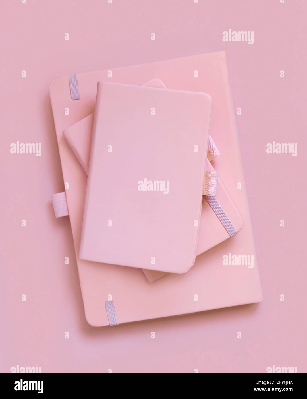 Stack of pink notebooks on light pink top view. Textbook mockup ...