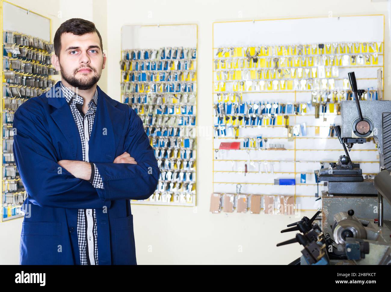 male worker showing his tools for making keys in workshop Stock Photo ...