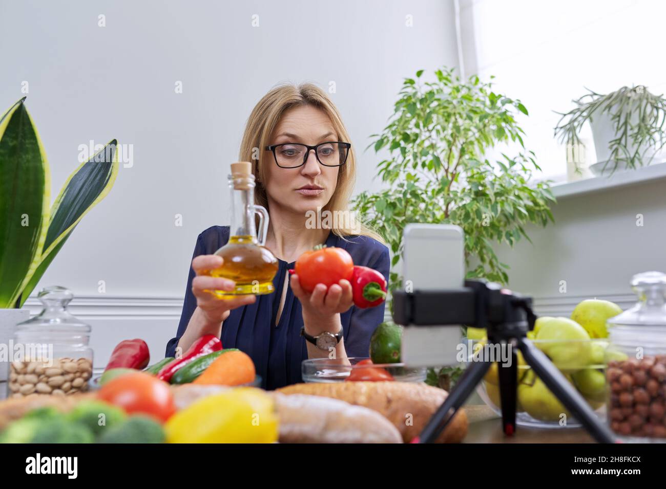 Woman nutritionist recording a video about healthy food, nutrition ...