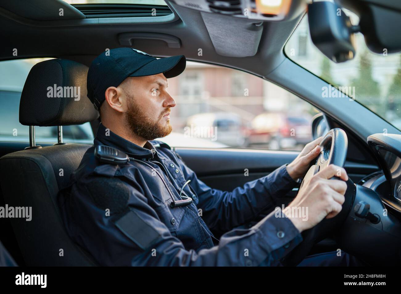 Male police officer in uniform poses in the car Stock Photo - Alamy
