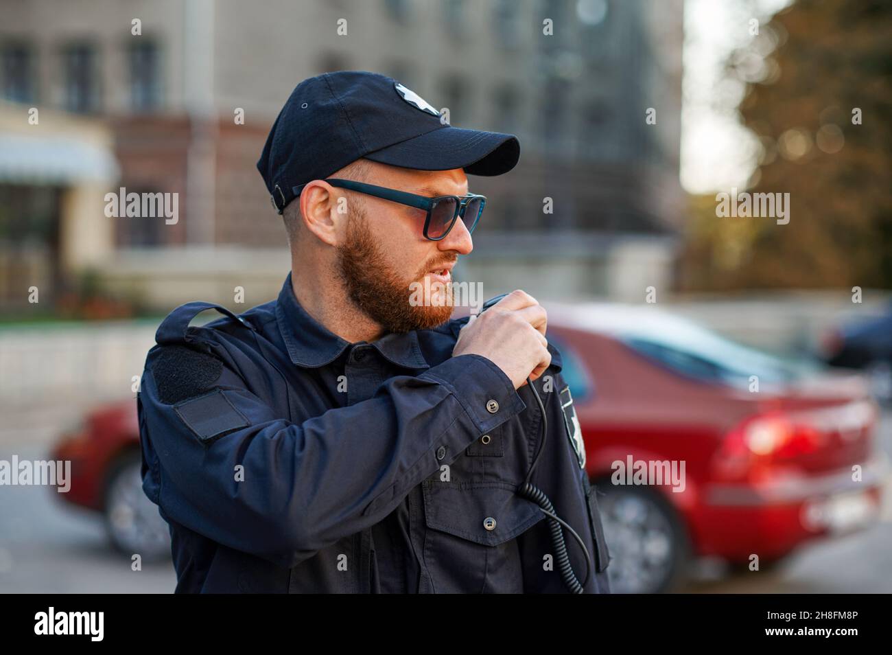 Police officer talking on the radio, car parking Stock Photo - Alamy