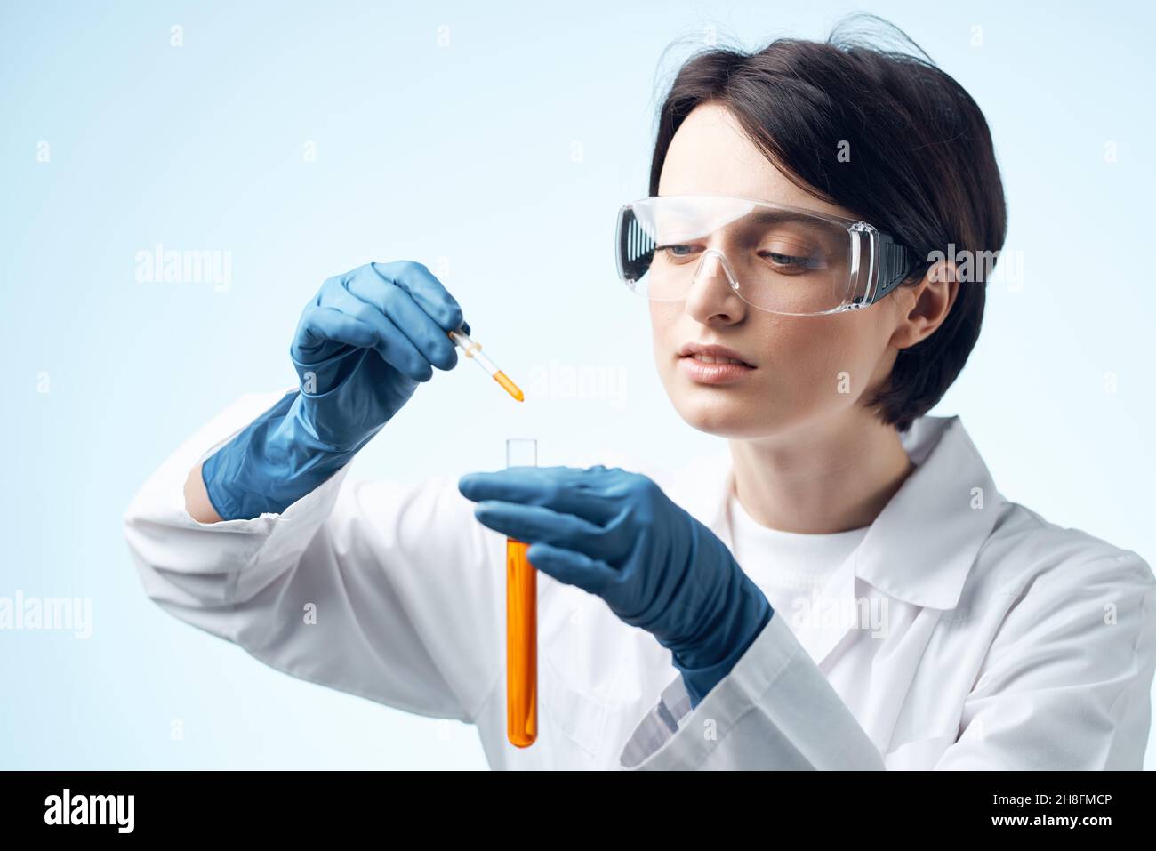 laboratory assistant sitting at the table microscope research ...