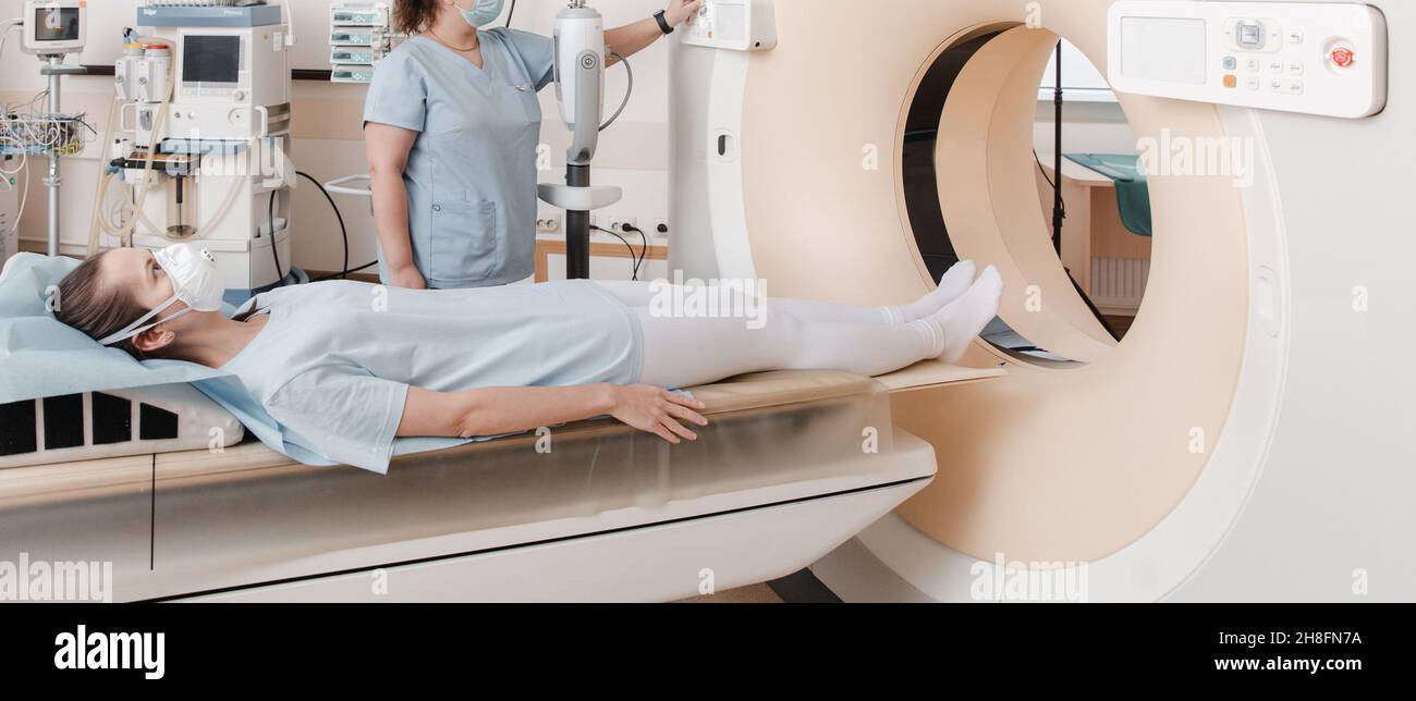 Doctor or nurse and patient with tomography CT or MRI Scan in hospital ...