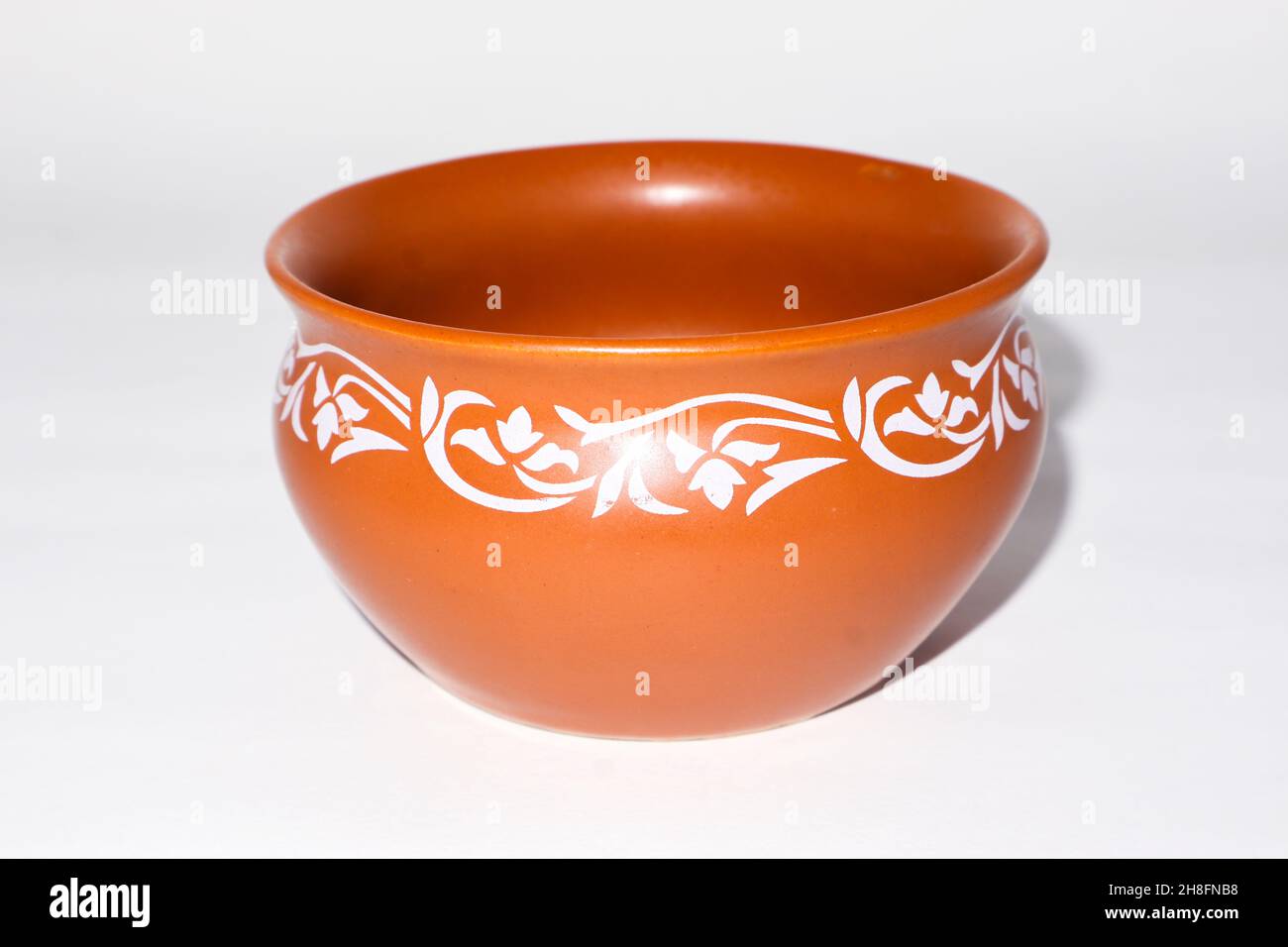 Empty clay pot on white background Stock Photo - Alamy