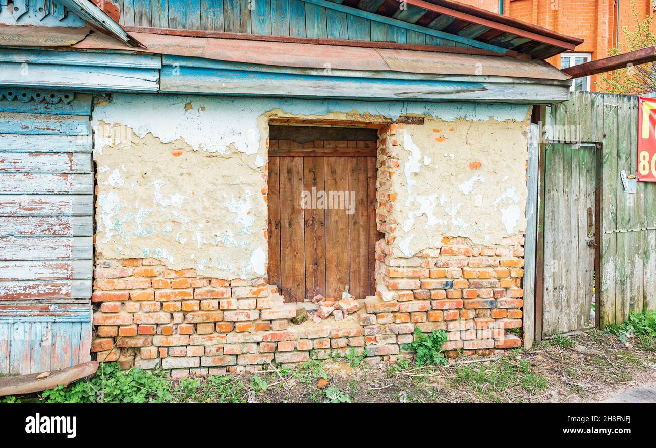 Old Russian brick house in dilapidated condition with boarded-up window ...