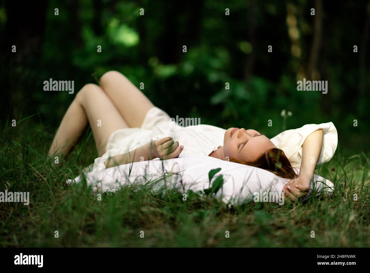 Healthy sound sleep. Rest, relaxation in the forest. Woman sleeps on a ...