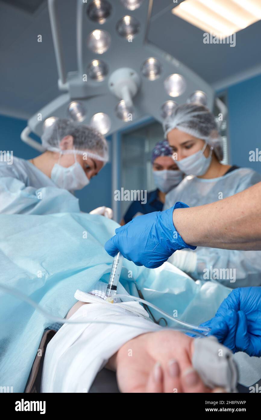 Concentrated Surgical team operating a patient in an operation theater ...