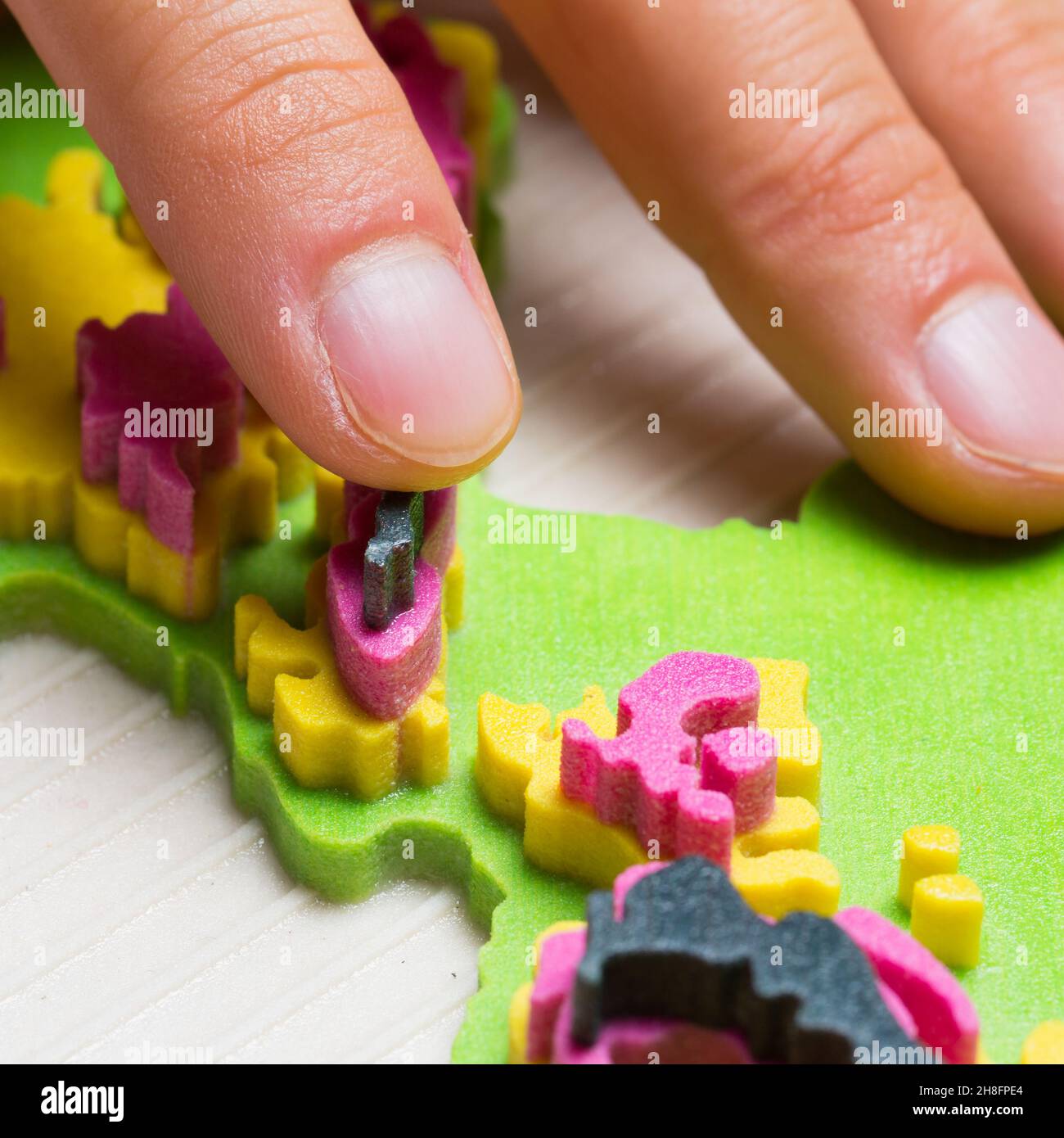 Fingers of a person with impaired vision, reading a special Braille map ...