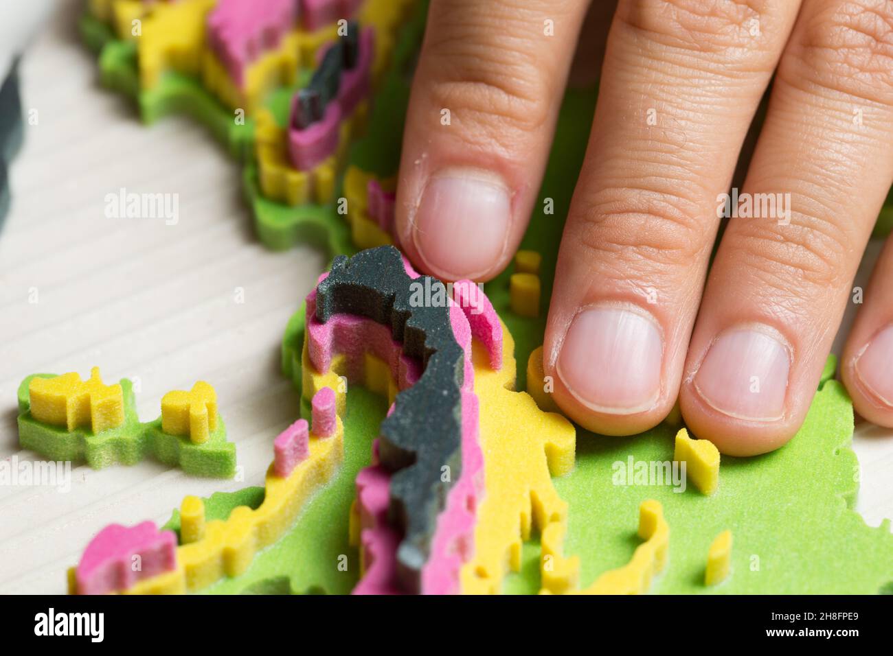 Fingers of a person with impaired vision, reading a special Braille map ...