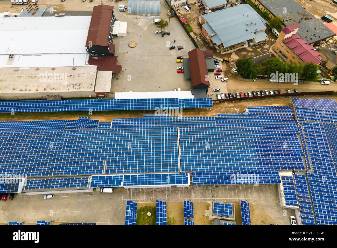 Aerial view of blue photovoltaic solar panels mounted on industrial ...