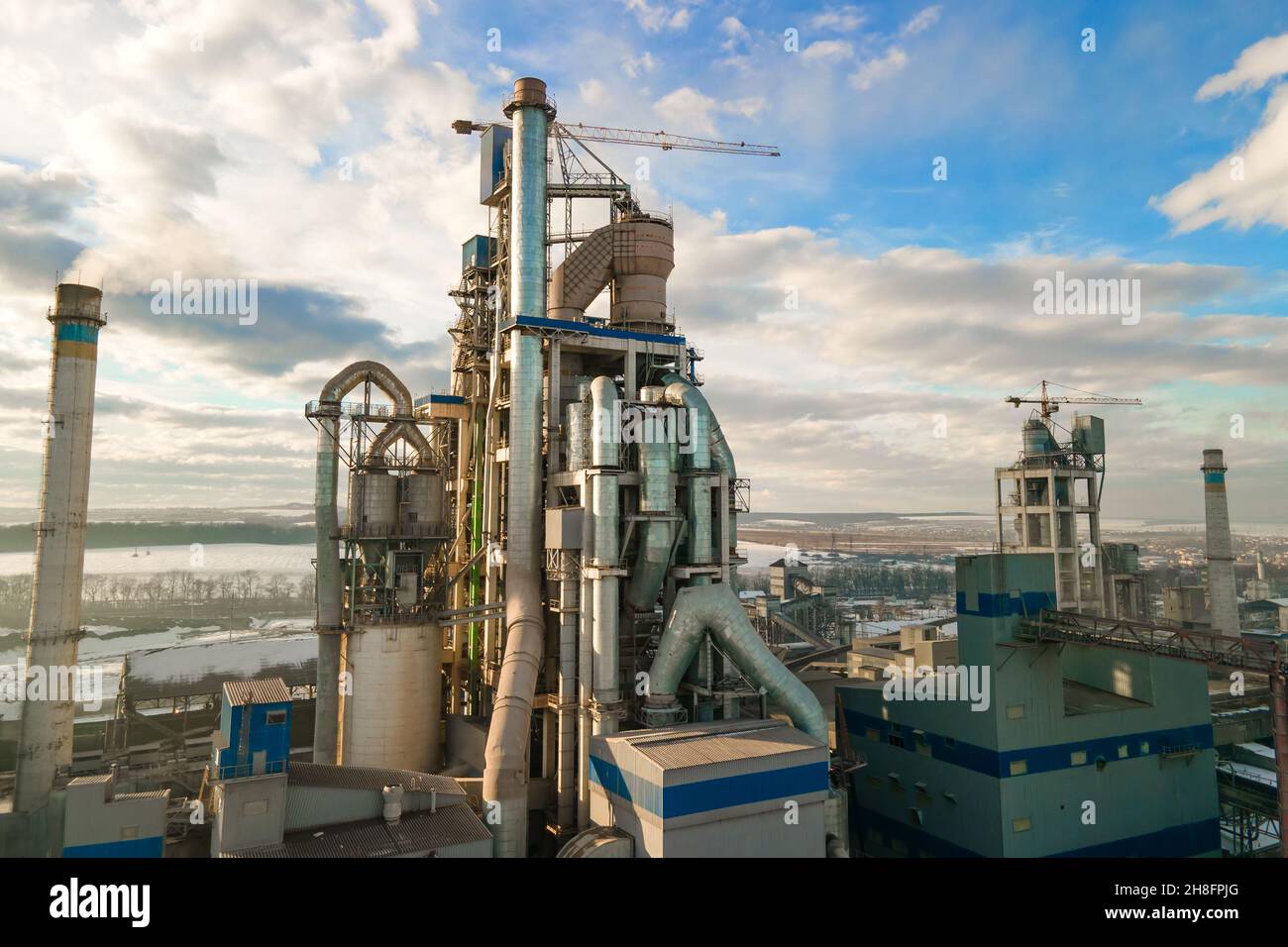 Aerial view of cement plant with high factory structure and tower crane ...