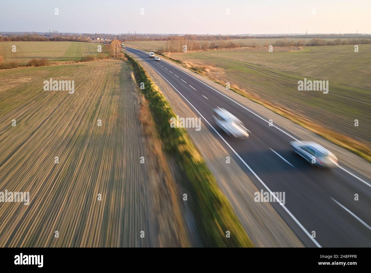 Aerial view of intercity road with fast driving cars at sunset. Top ...