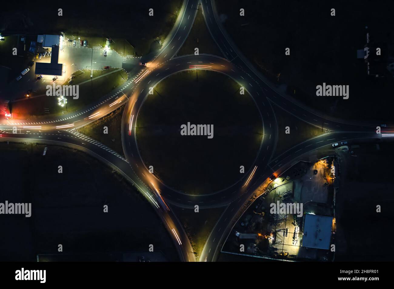 Aerial view of road roundabout intersection with fast moving heavy ...