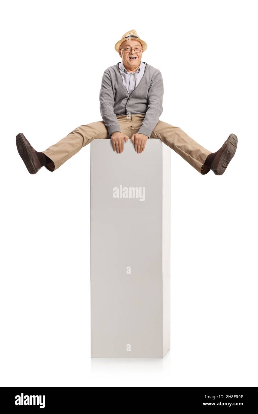 Cheerful elderly man sitting on a tall white column isolated on white ...