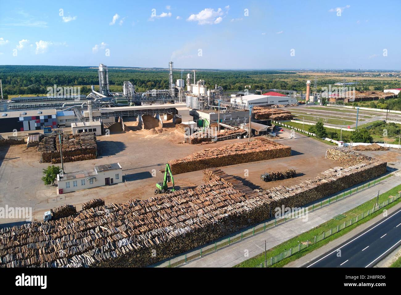 Aerial view of wood processing factory with stacks of lumber at plant ...
