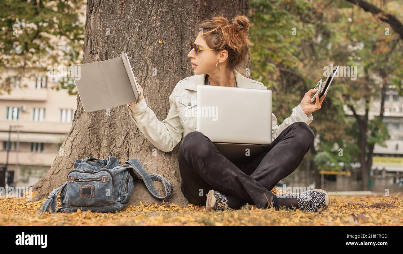 Hysterical young girl with too many screens, mobile phones, tablets and ...