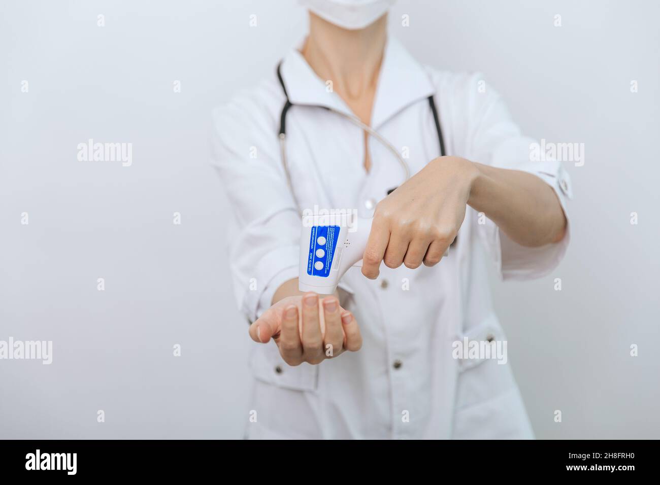 Temperature measurement gun in doctor hands. Close-up shot of doctor ...