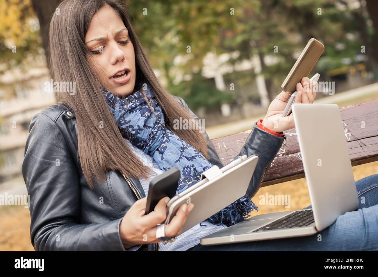 Hysterical young girl with too many screens, mobile phones, tablets and ...