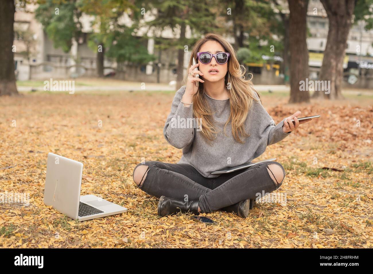 Hysterical young girl with too many screens, mobile phones, tablets and ...