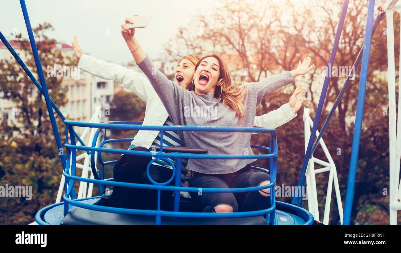 Girls riding merry go round hi-res stock photography and images - Alamy