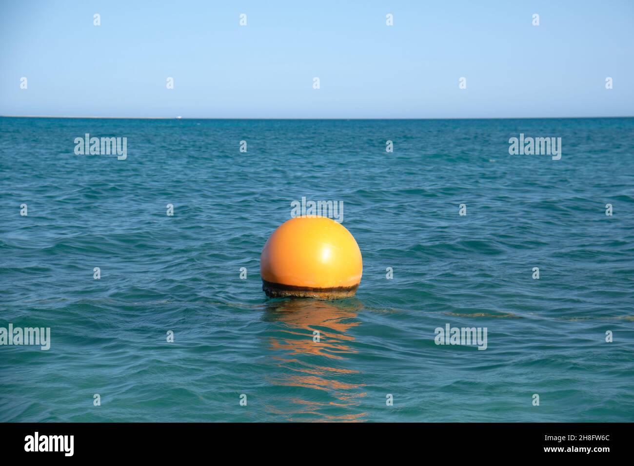 Orange buoy floating on sea surface waves. Human life safety concept ...