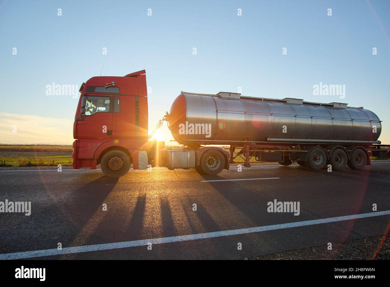 Petrol cargo truck driving on highway hauling oil products. Delivery ...