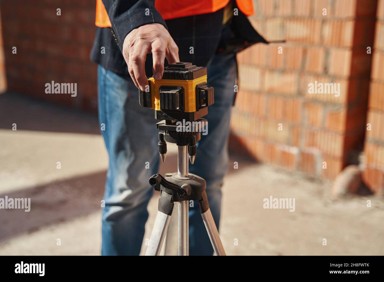 Laser level being used in professional construction process Stock Photo ...