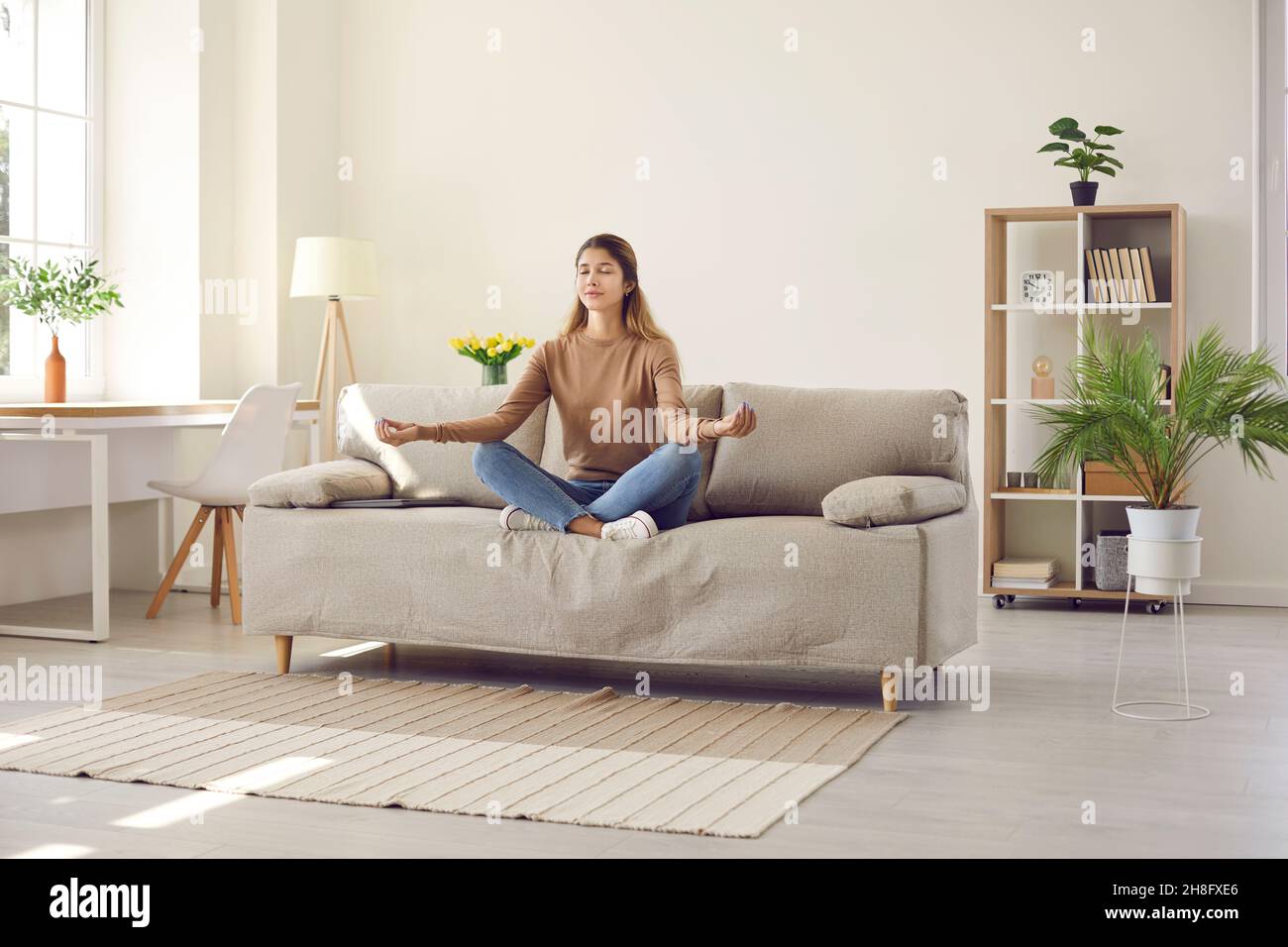 Meditation home on couch hi-res stock photography and images - Alamy
