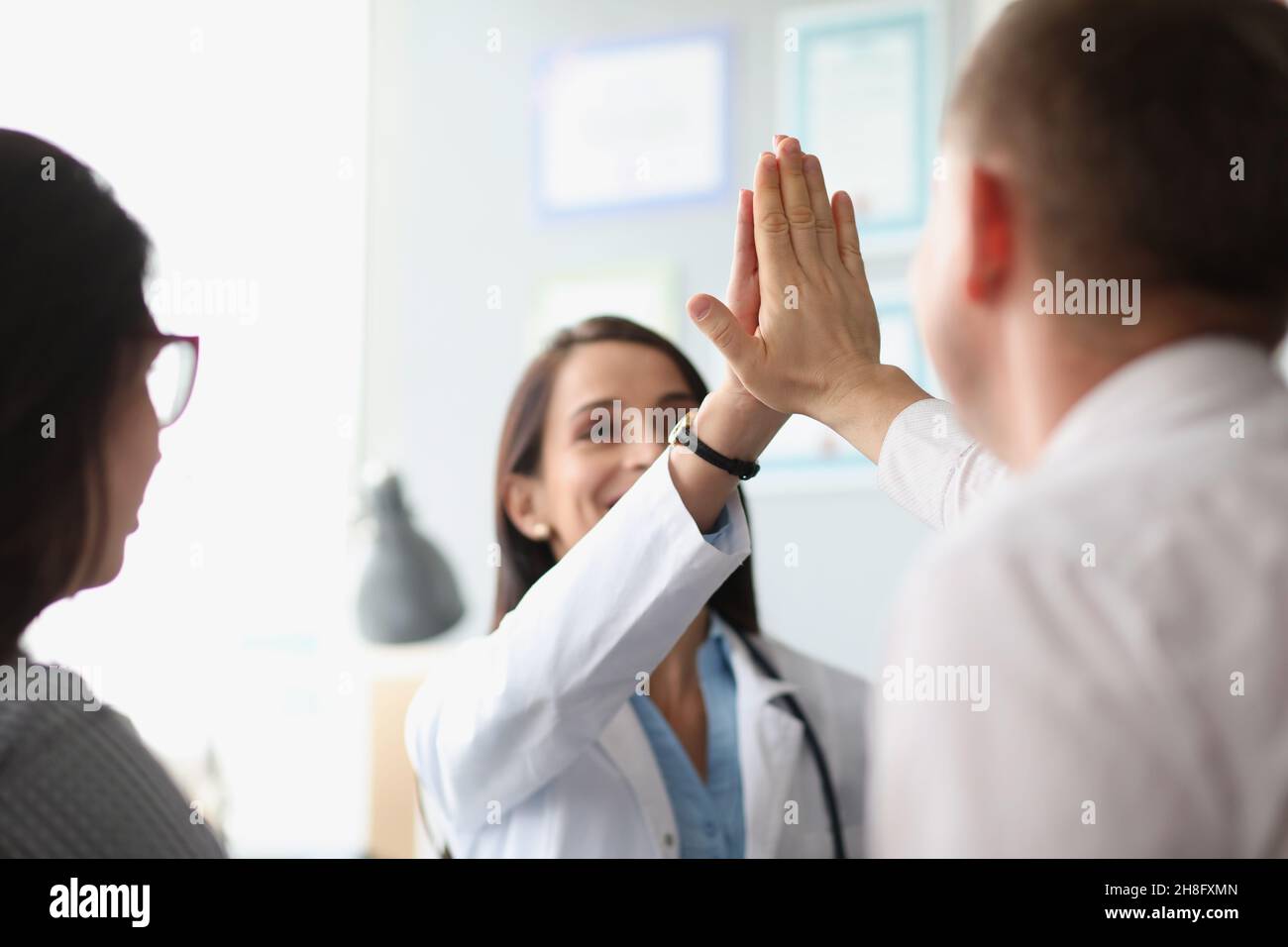Happy colleagues give high five hi-res stock photography and images - Alamy