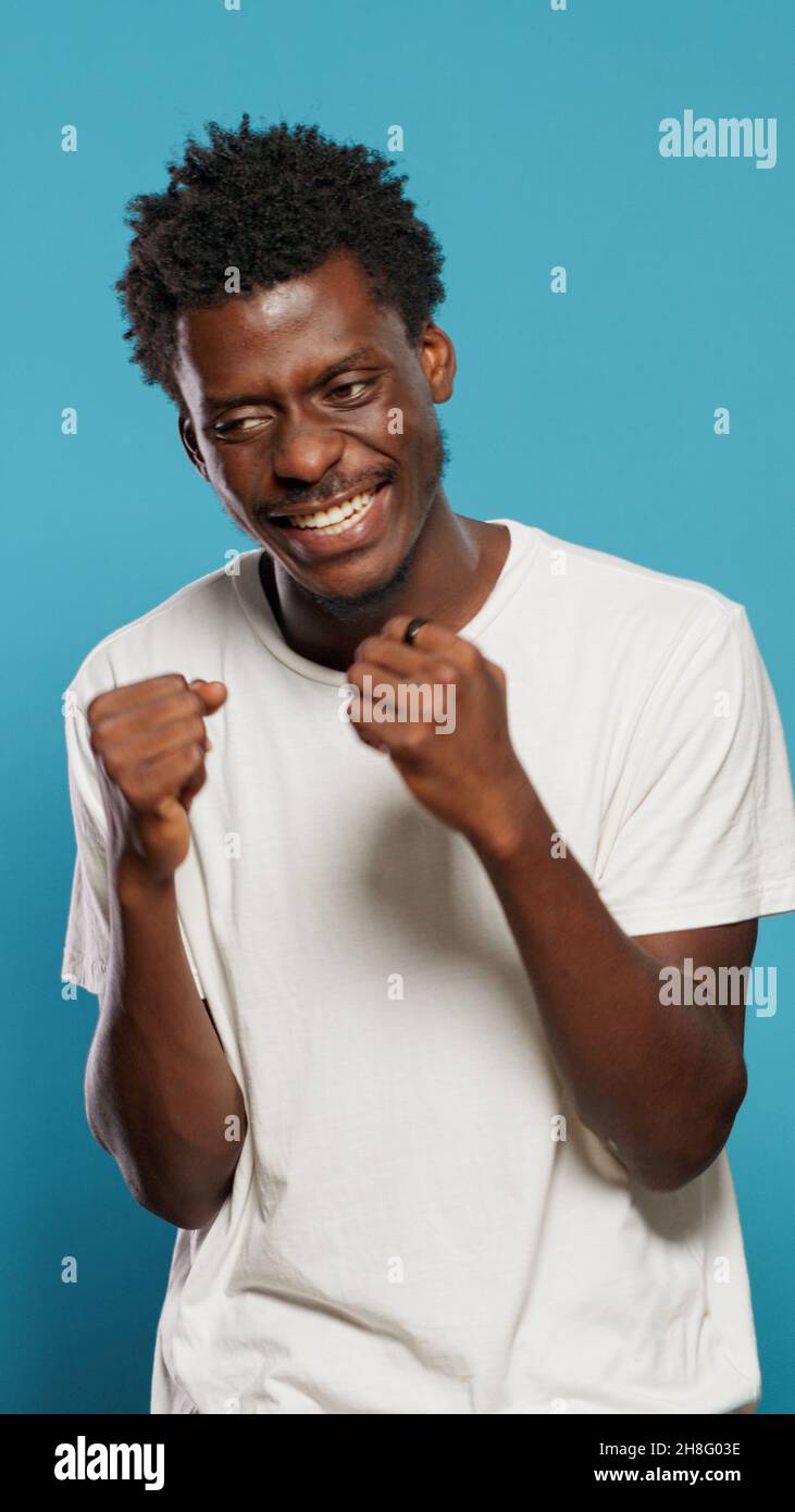 Angry man showing emotions and clenching fists in studio. Portrait of ...