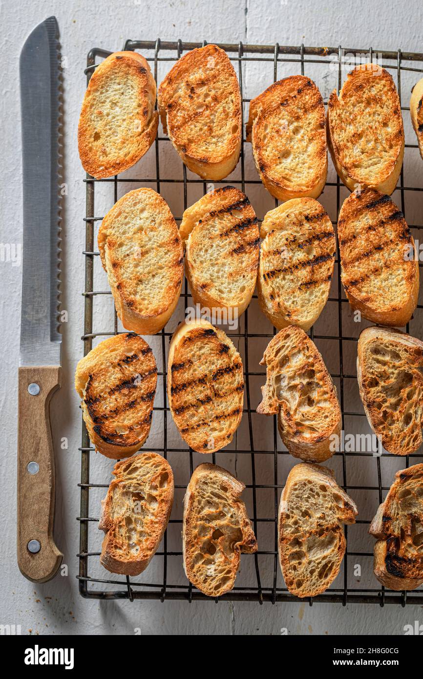 Homemade toasted wholegrain bread. Small golden toast on grill grate ...