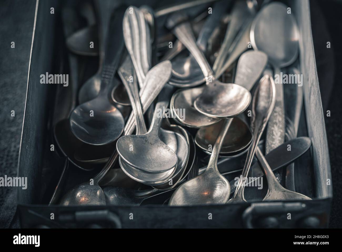 Old vintage spoons in a rustic box. Antique used cutlery Stock Photo ...