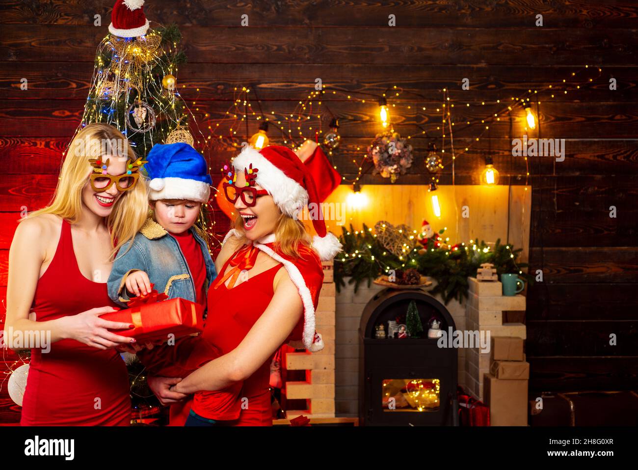 Kid boy with mom or aunts sisters having fun. Christmas family fun ...